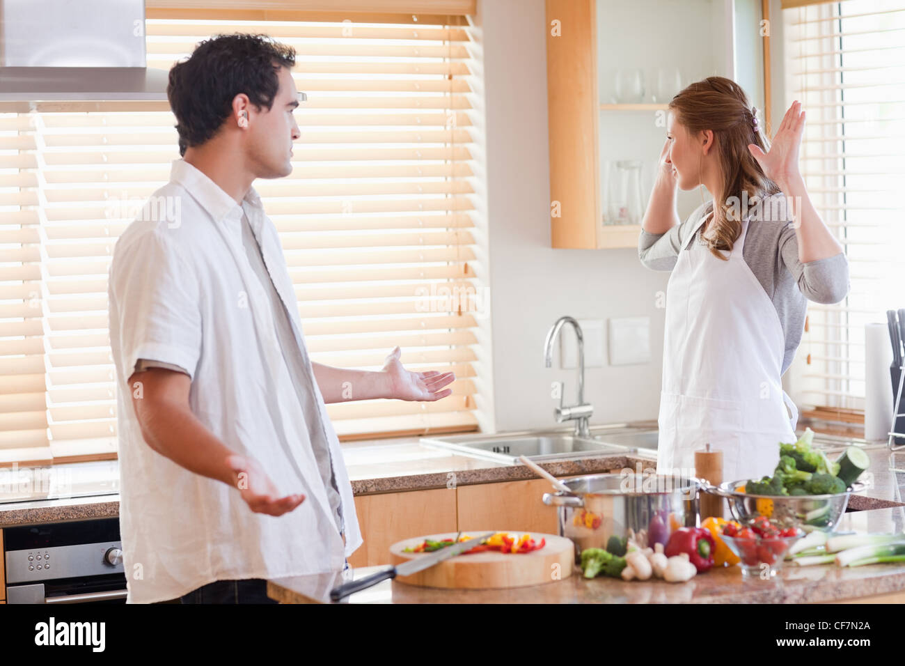 Couple disputing in the kitchen Stock Photo - Alamy