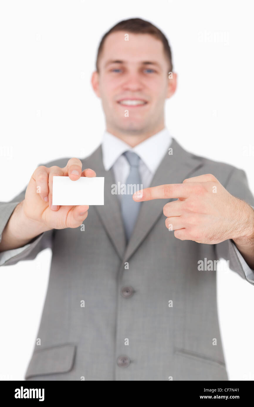 Portrait of a young businessman pointing at a blank business card Stock ...
