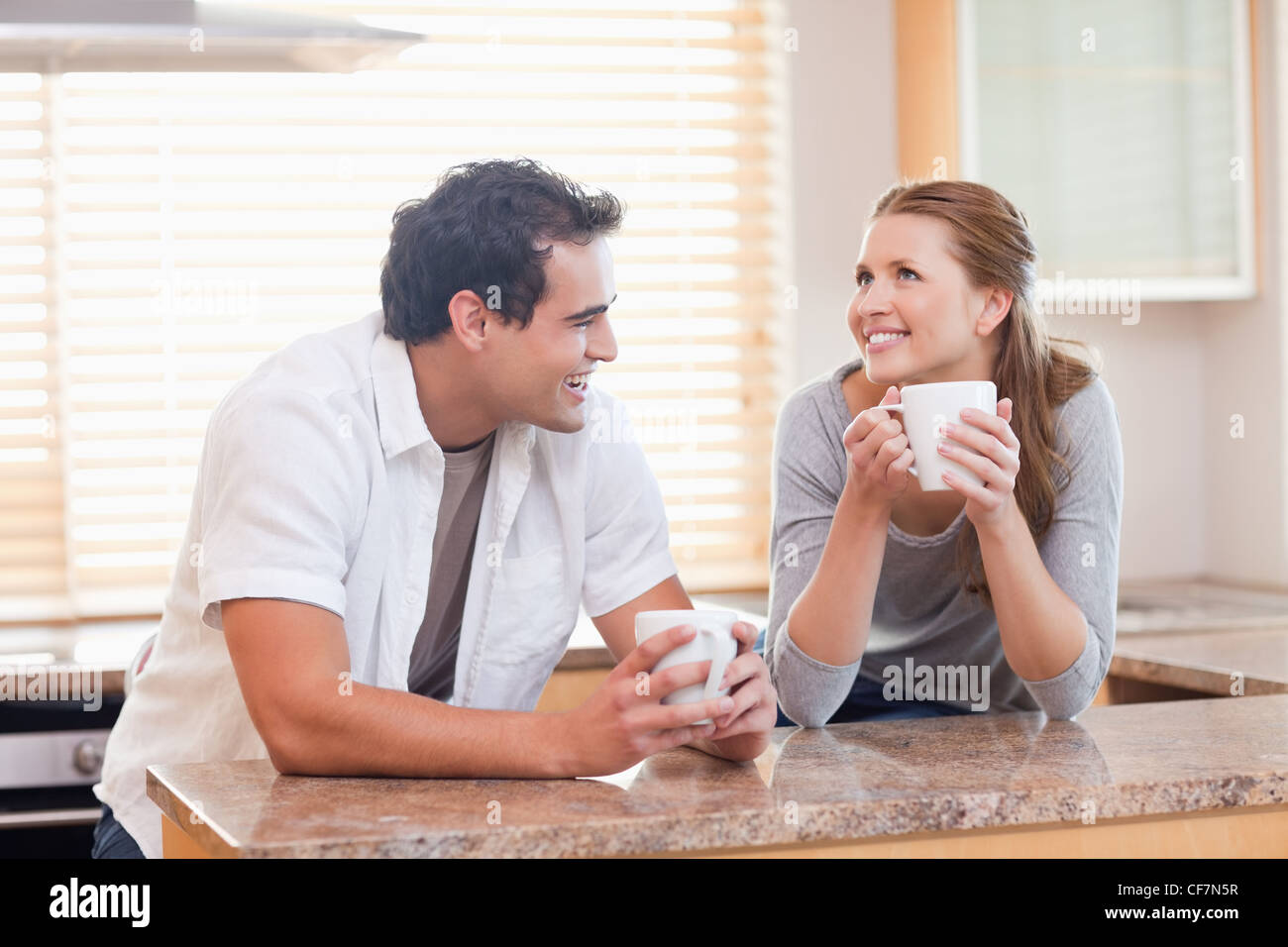 Cheerful couple having coffee together Stock Photo - Alamy