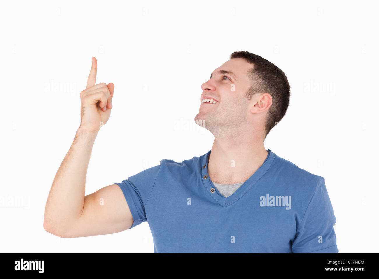 Smiling man pointing at something Stock Photo - Alamy