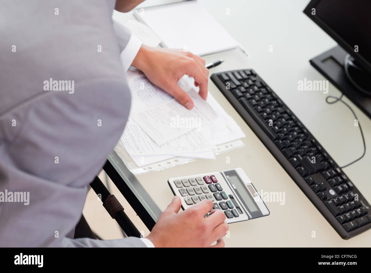 Above view of businessman using table calculator Stock Photo - Alamy