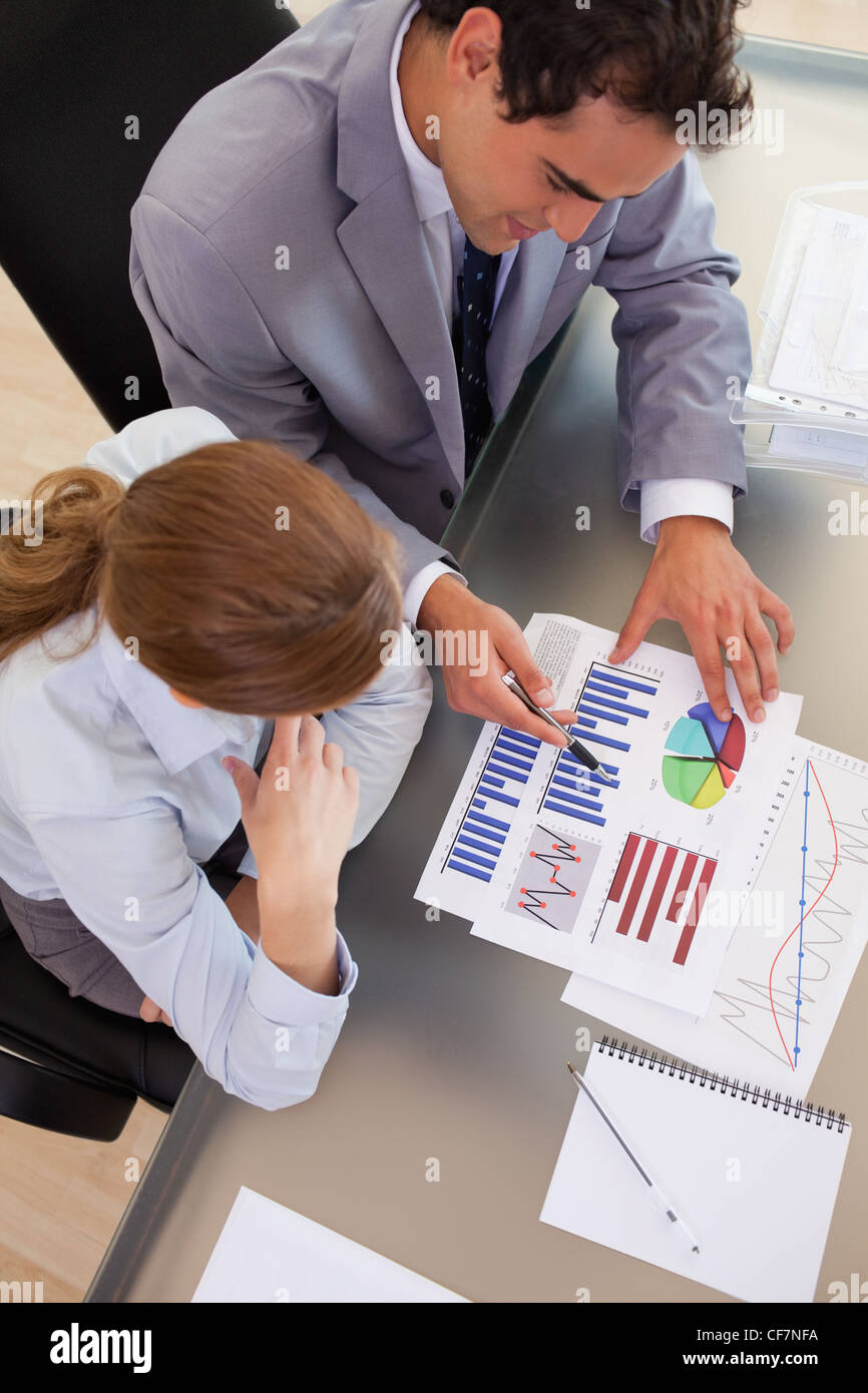 Above view of business people working with statistics Stock Photo - Alamy