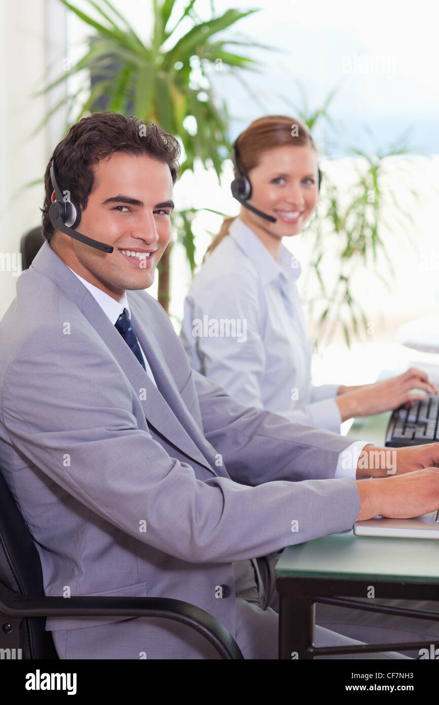 Side view of call center agents Stock Photo - Alamy