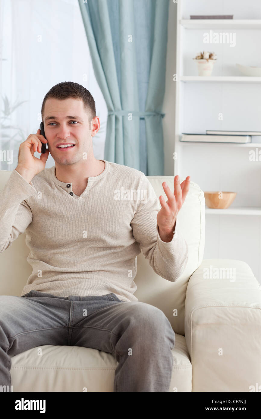 Man relaxing looking through his phone hi-res stock photography and ...