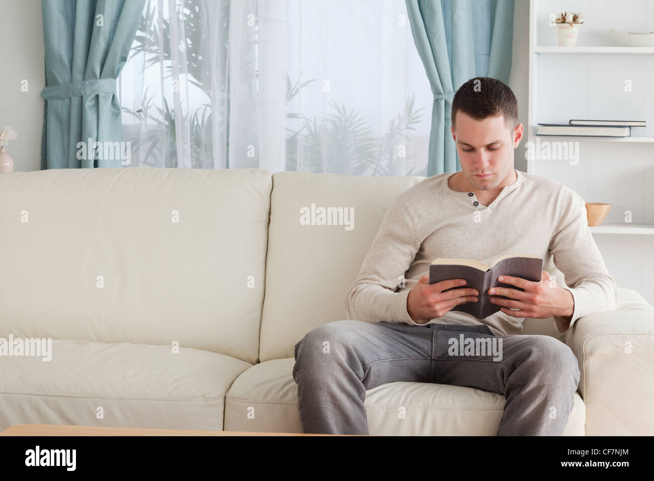 Man reading a book Stock Photo - Alamy