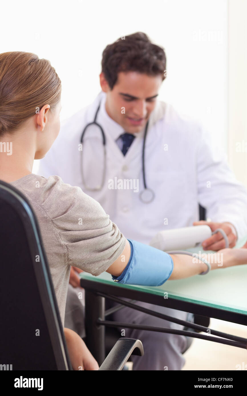 Doctor checking his patients blood pressure Stock Photo - Alamy