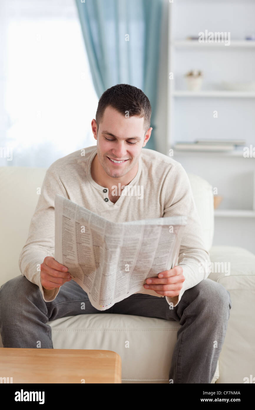 Portrait of a handsome man reading a newspaper Stock Photo - Alamy
