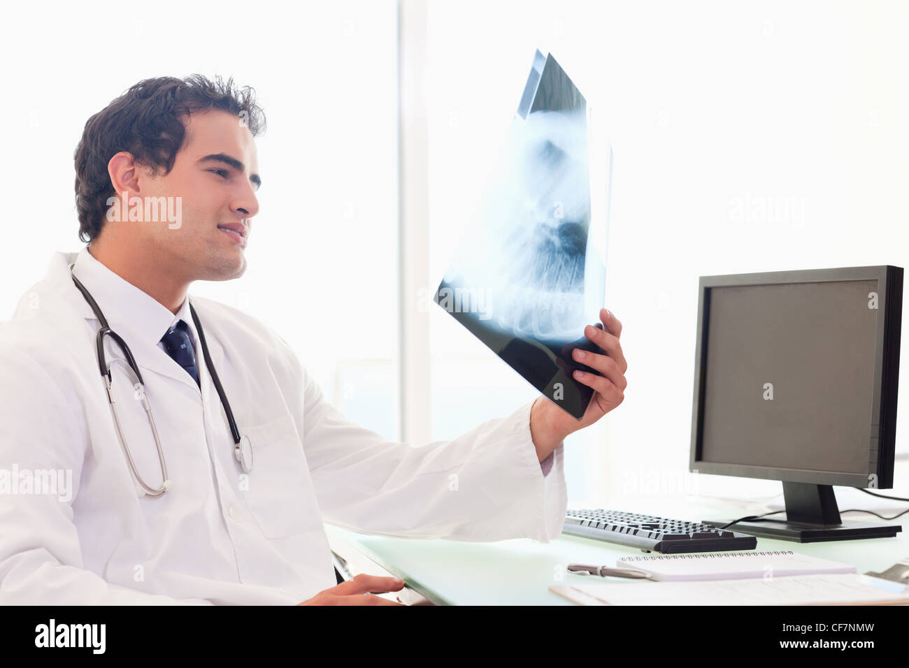 Doctor looking at x-ray Stock Photo - Alamy