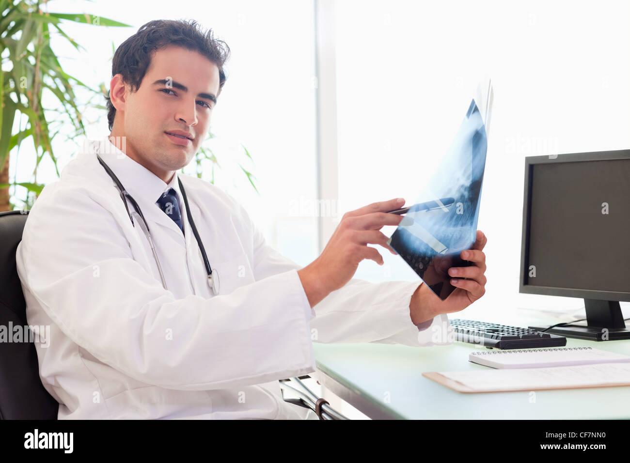 Side view of doctor sitting in his office with an x-ray Stock Photo - Alamy