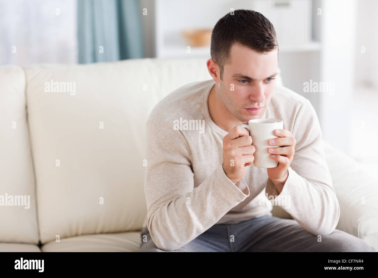 Young man having a coffee Stock Photo - Alamy