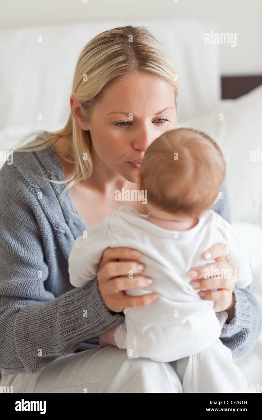 Baby sitting on mothers lap Stock Photo - Alamy