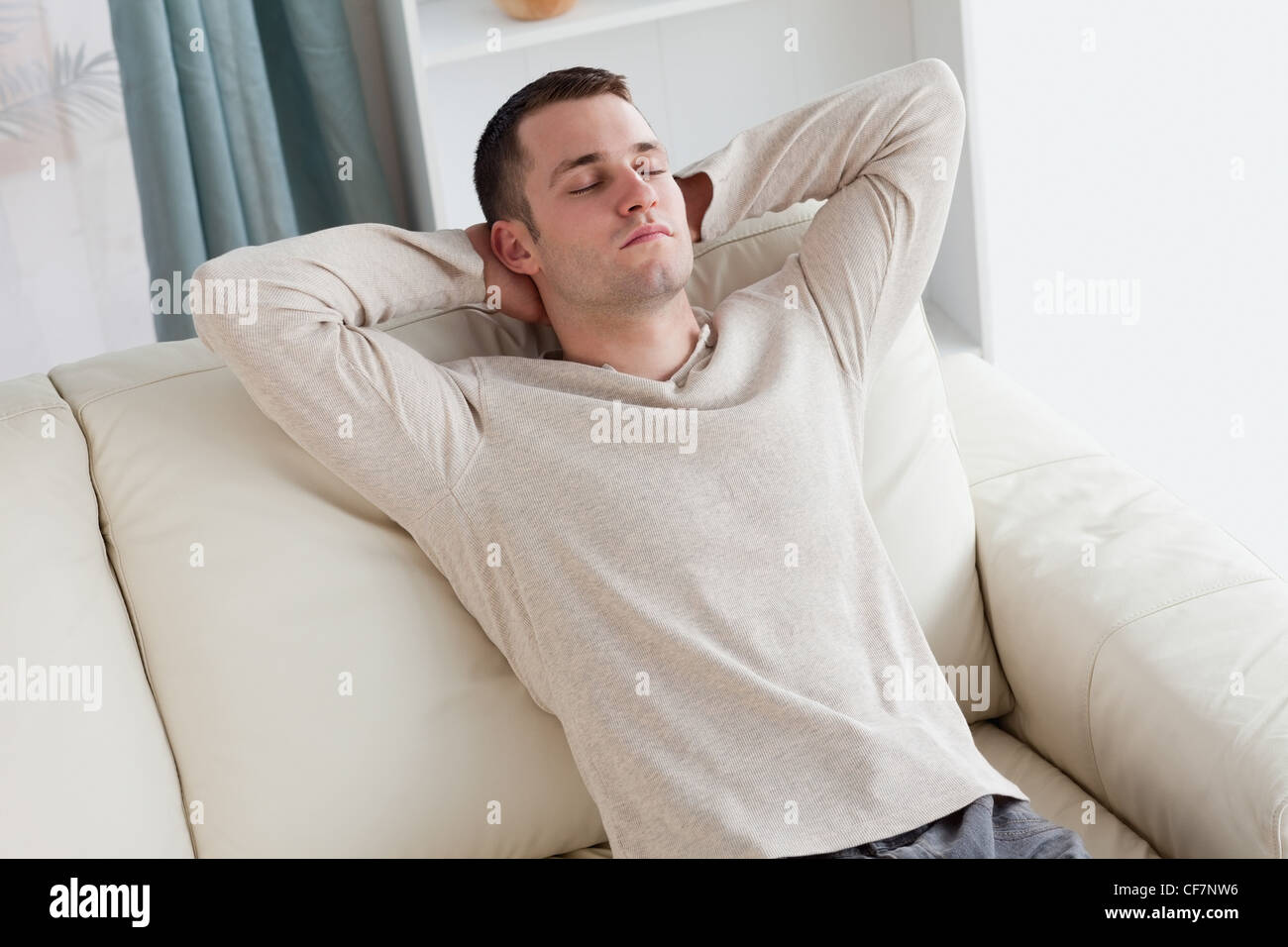 Man resting on a sofa Stock Photo - Alamy