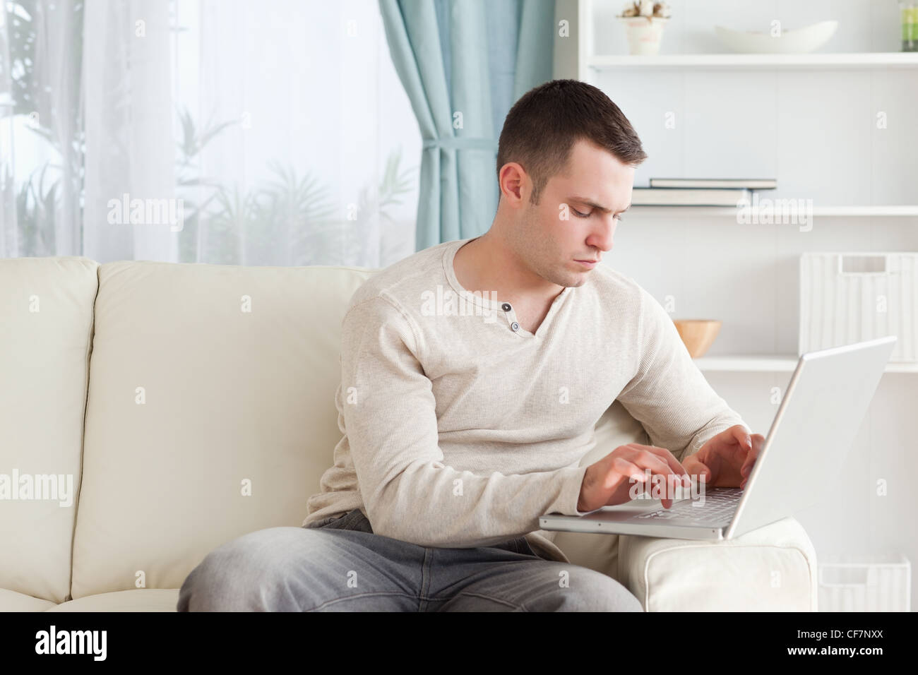 Man typing on his laptop Stock Photo - Alamy