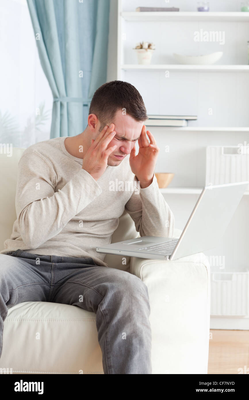 Young man headache using laptop hi-res stock photography and images - Alamy