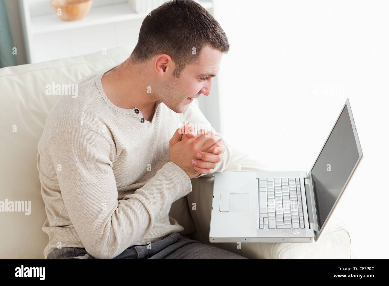 Young man using a laptop Stock Photo - Alamy