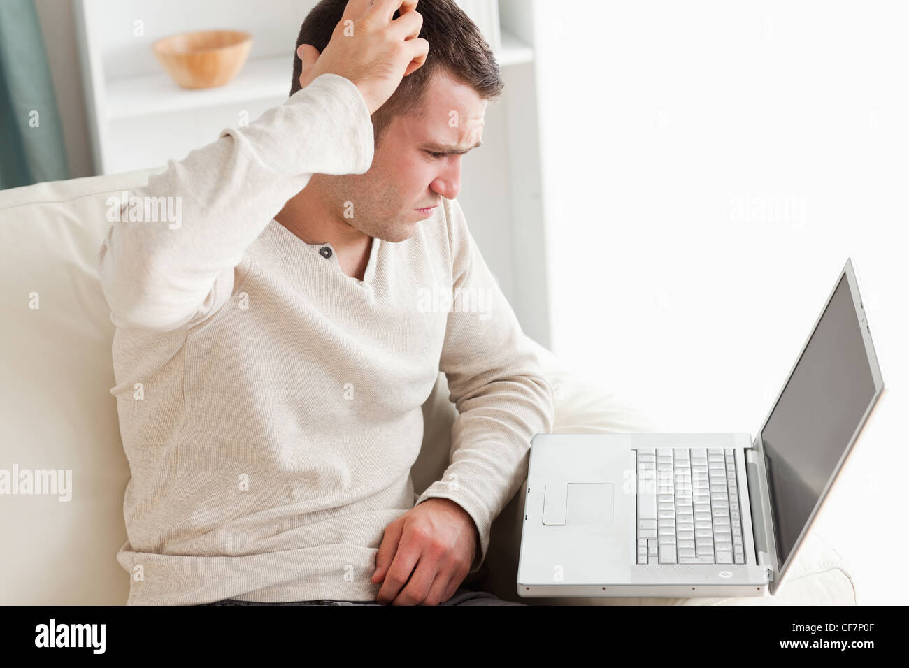 Confused young man using notebook hi-res stock photography and images ...