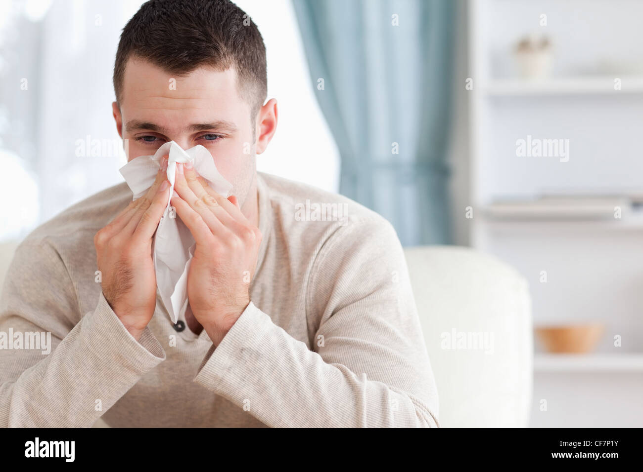 Man blowing his nose Stock Photo - Alamy