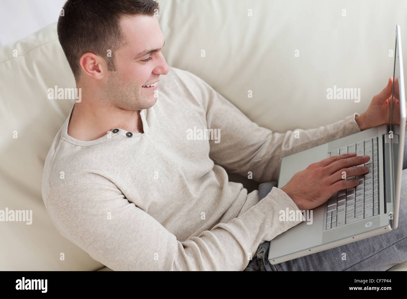 Happy man relaxing with a notebook Stock Photo - Alamy