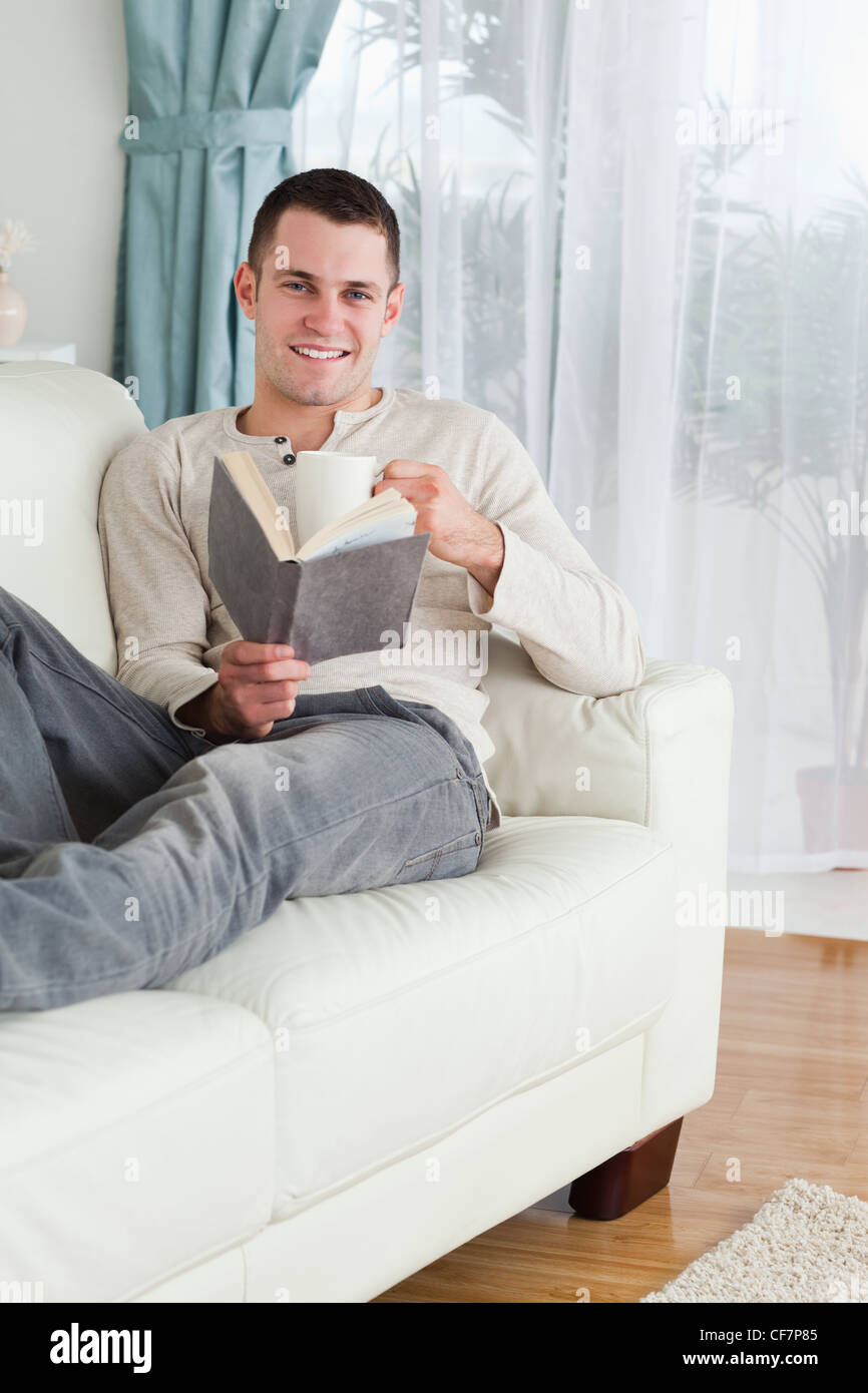 Portrait of a happy man reading a book Stock Photo - Alamy