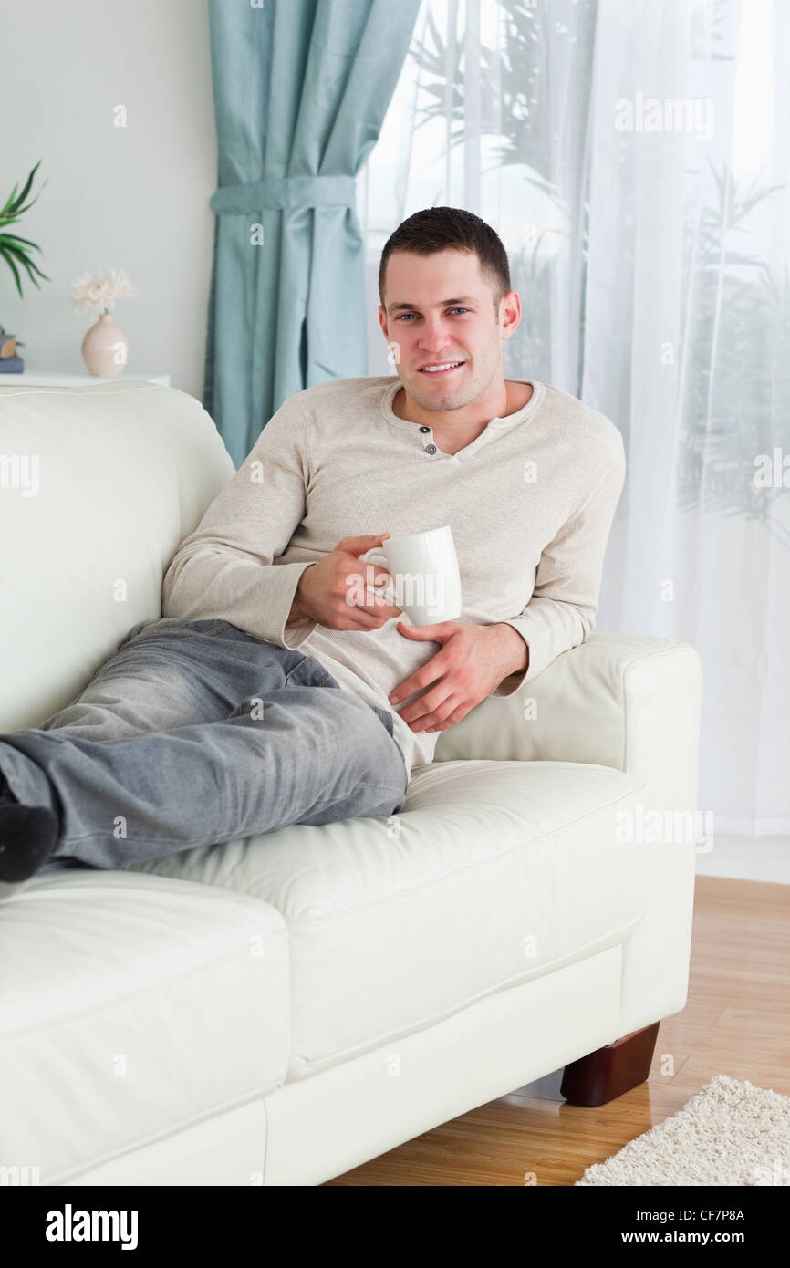 Man holding a cup of tea Stock Photo - Alamy