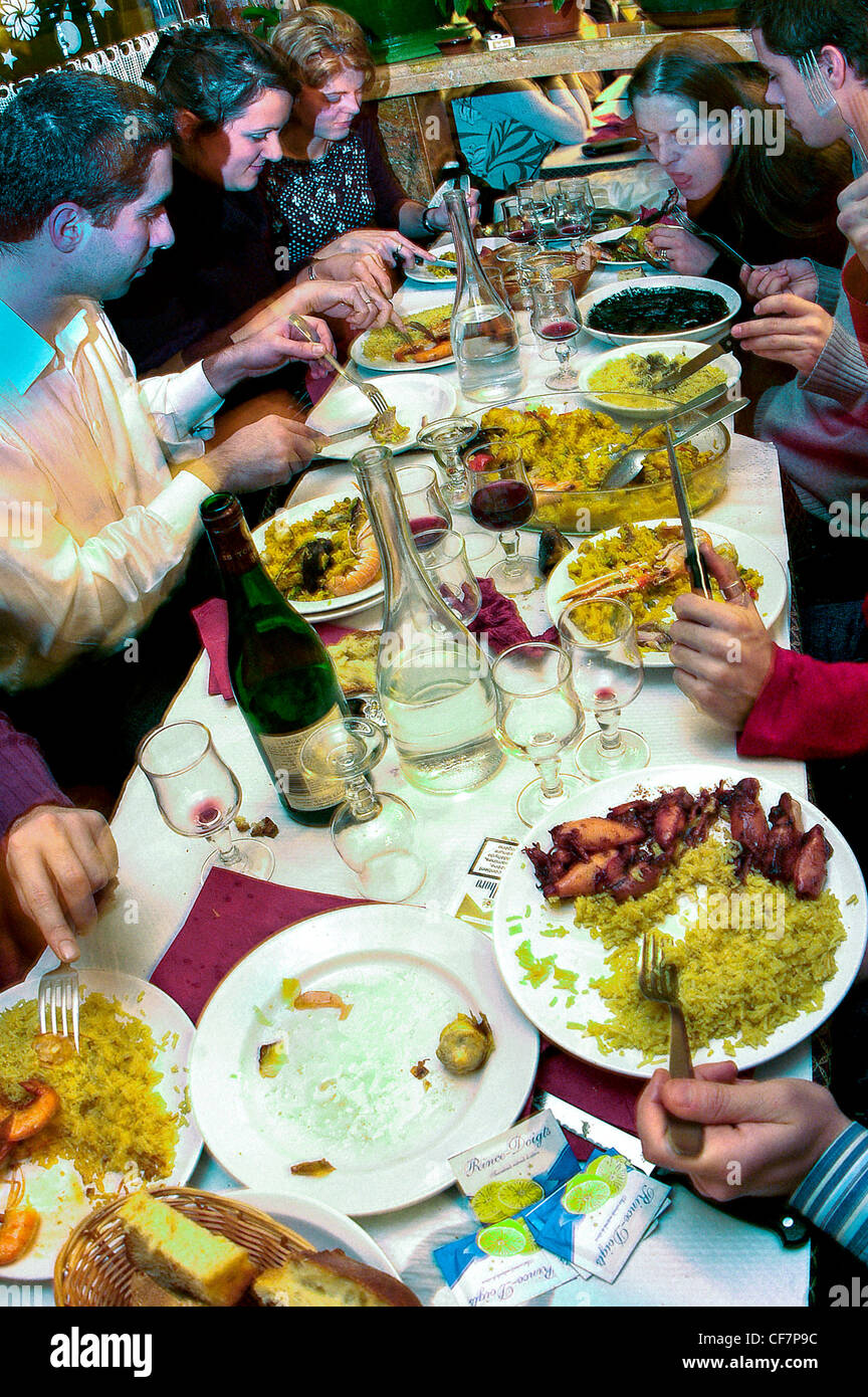 Paris, France, Young Adults Sharing Meals at Crowded Table in Spanish ...