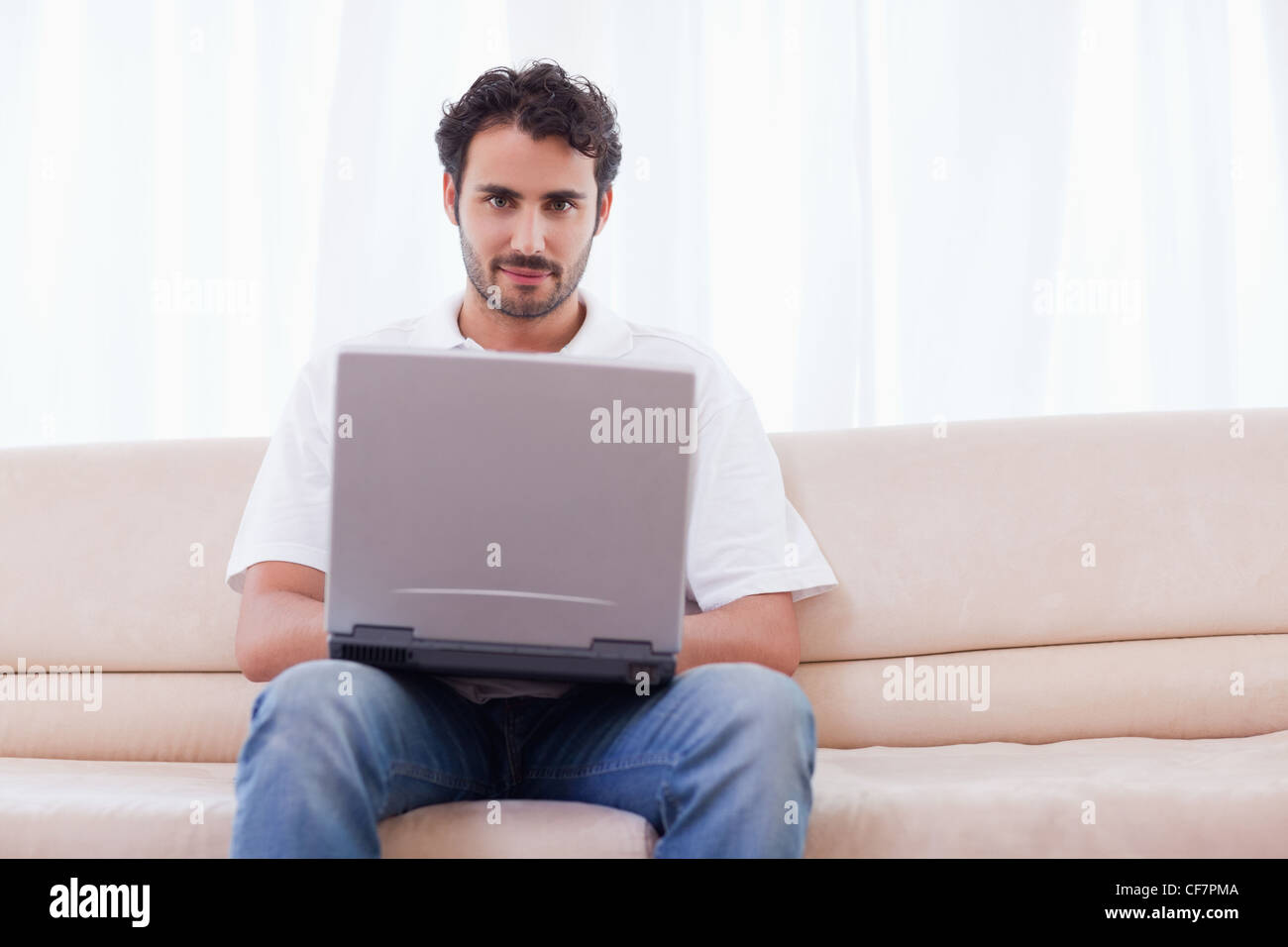 Young man using a notebook Stock Photo - Alamy
