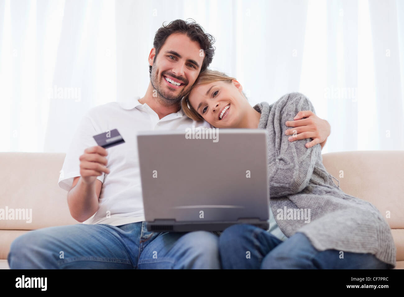 Smiling couple shopping online Stock Photo - Alamy