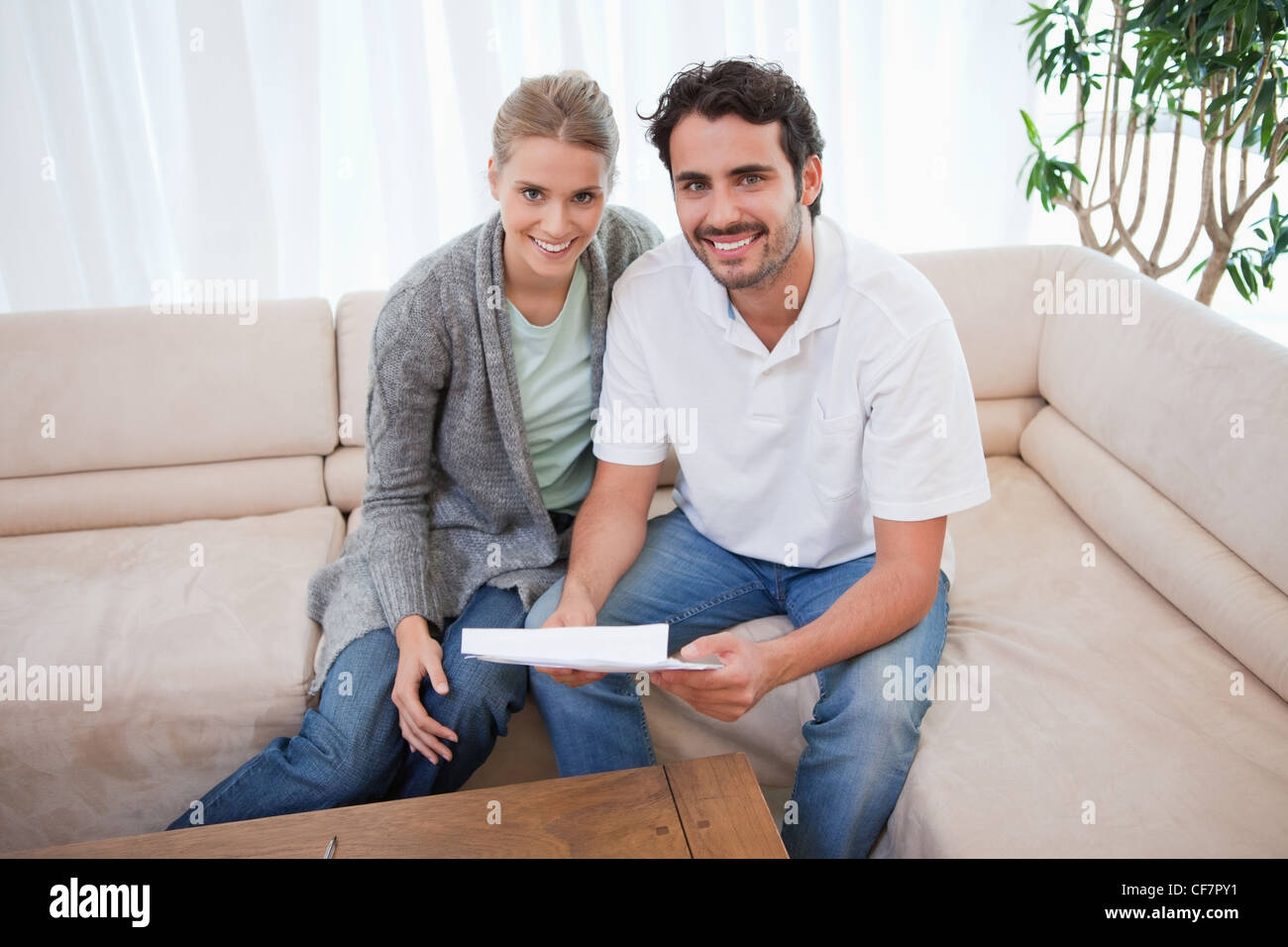 Smiling couple reading a letter Stock Photo - Alamy