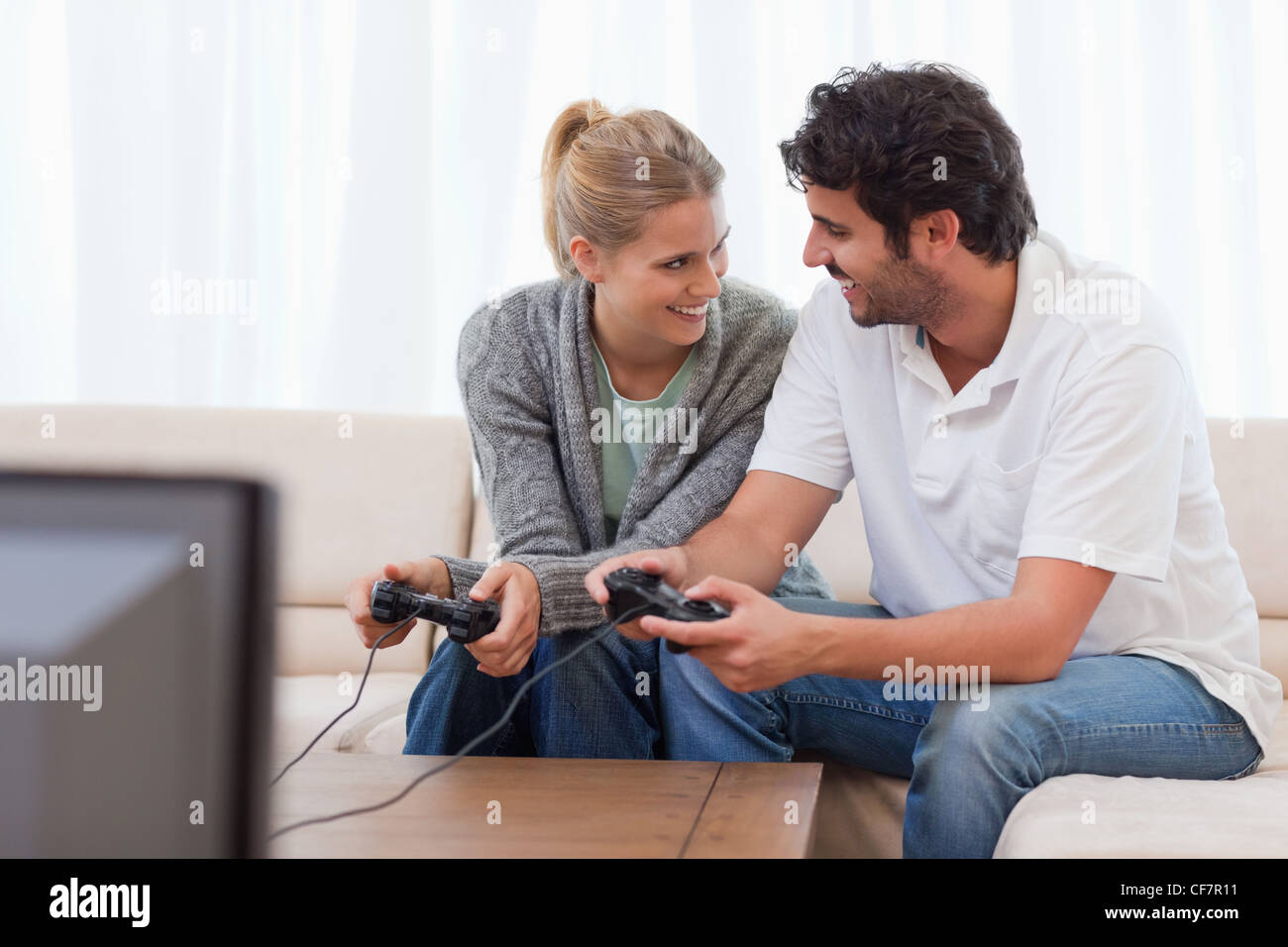 Happy couple playing video games Stock Photo - Alamy