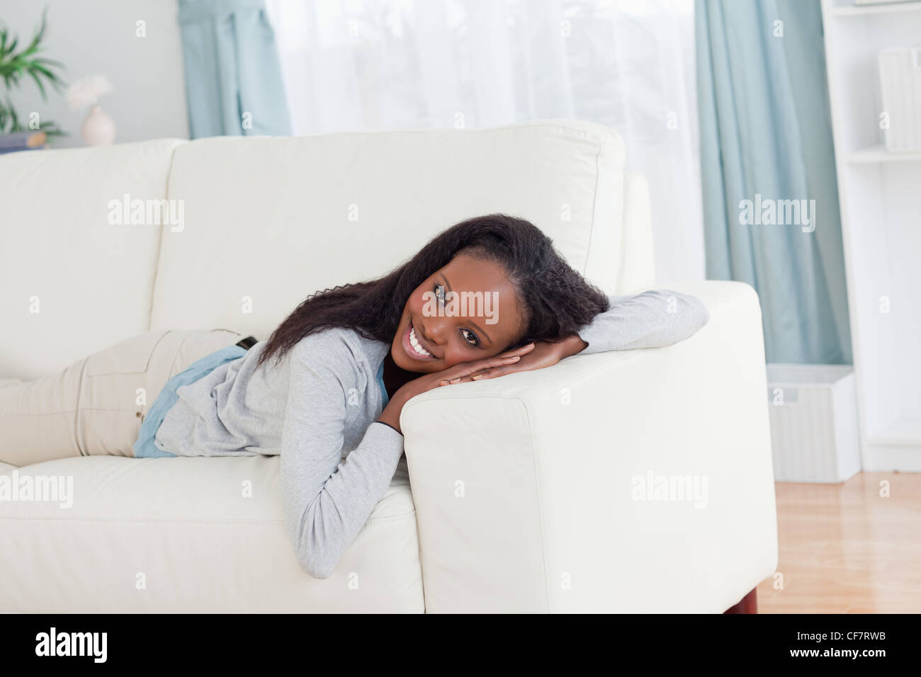 Woman resting on couch Stock Photo - Alamy