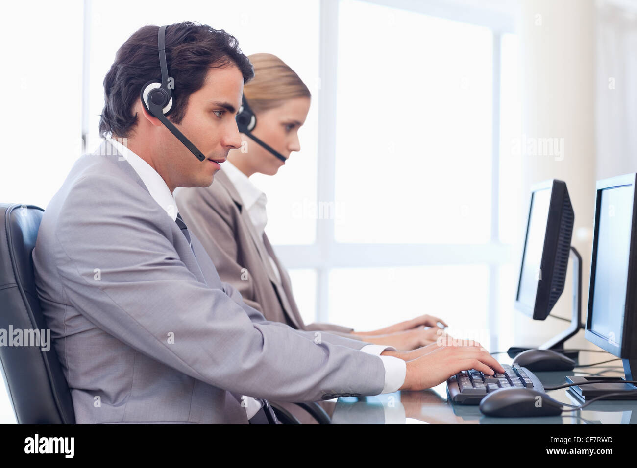 Operators using a computer Stock Photo - Alamy