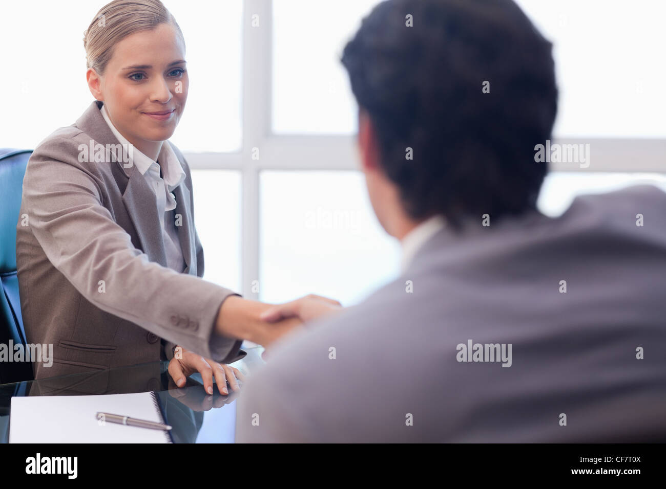 Businesswoman receiving a customer Stock Photo - Alamy