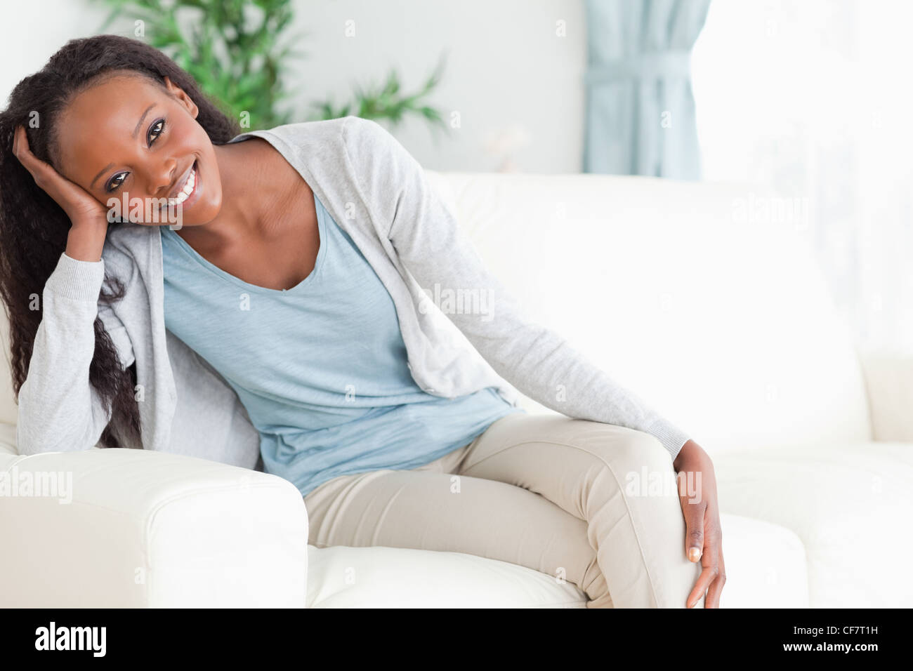 Young woman sofa armrest hi-res stock photography and images - Alamy