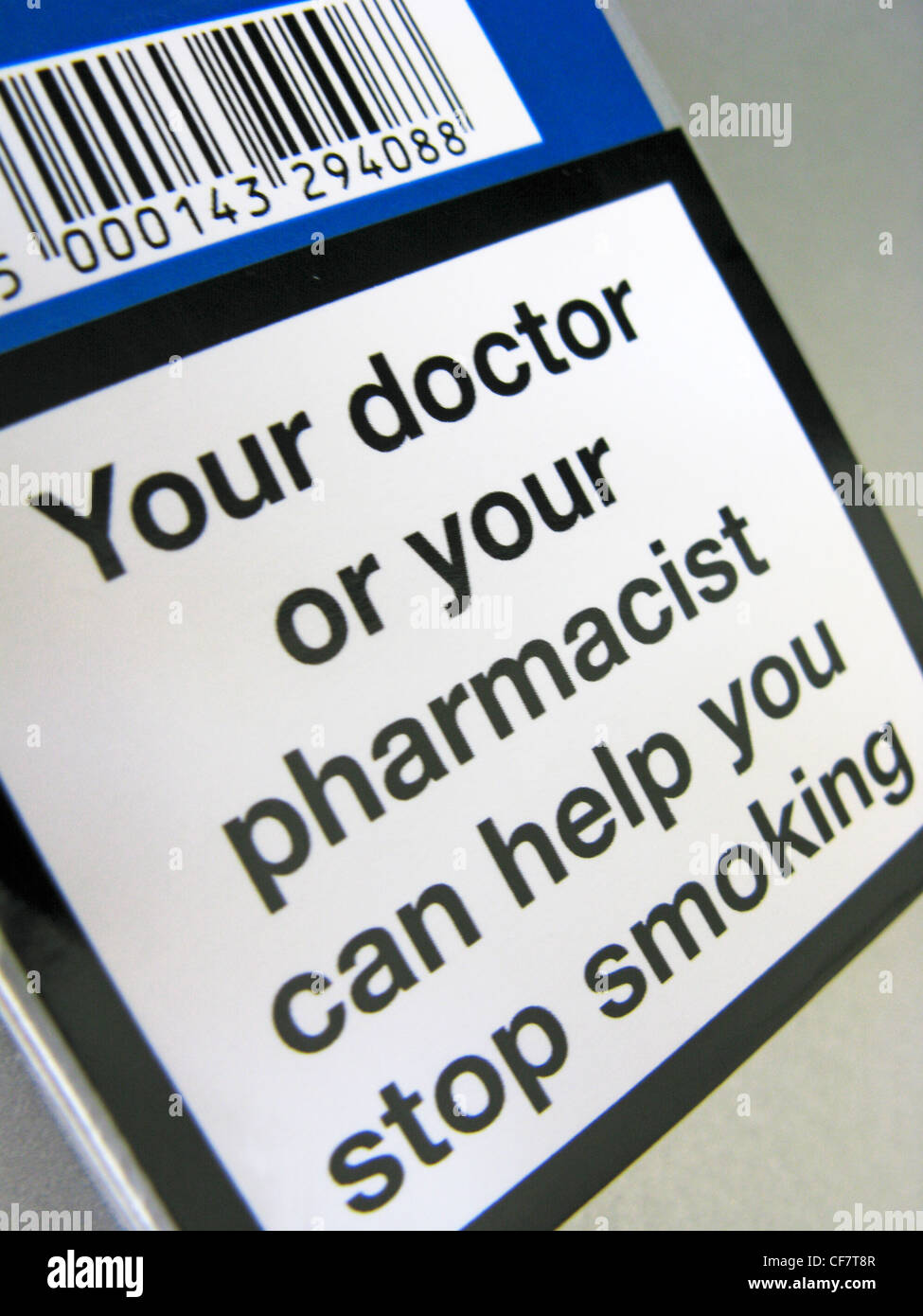 A cigarette packet with a warning on, indicating a doctor or pharmacist ...
