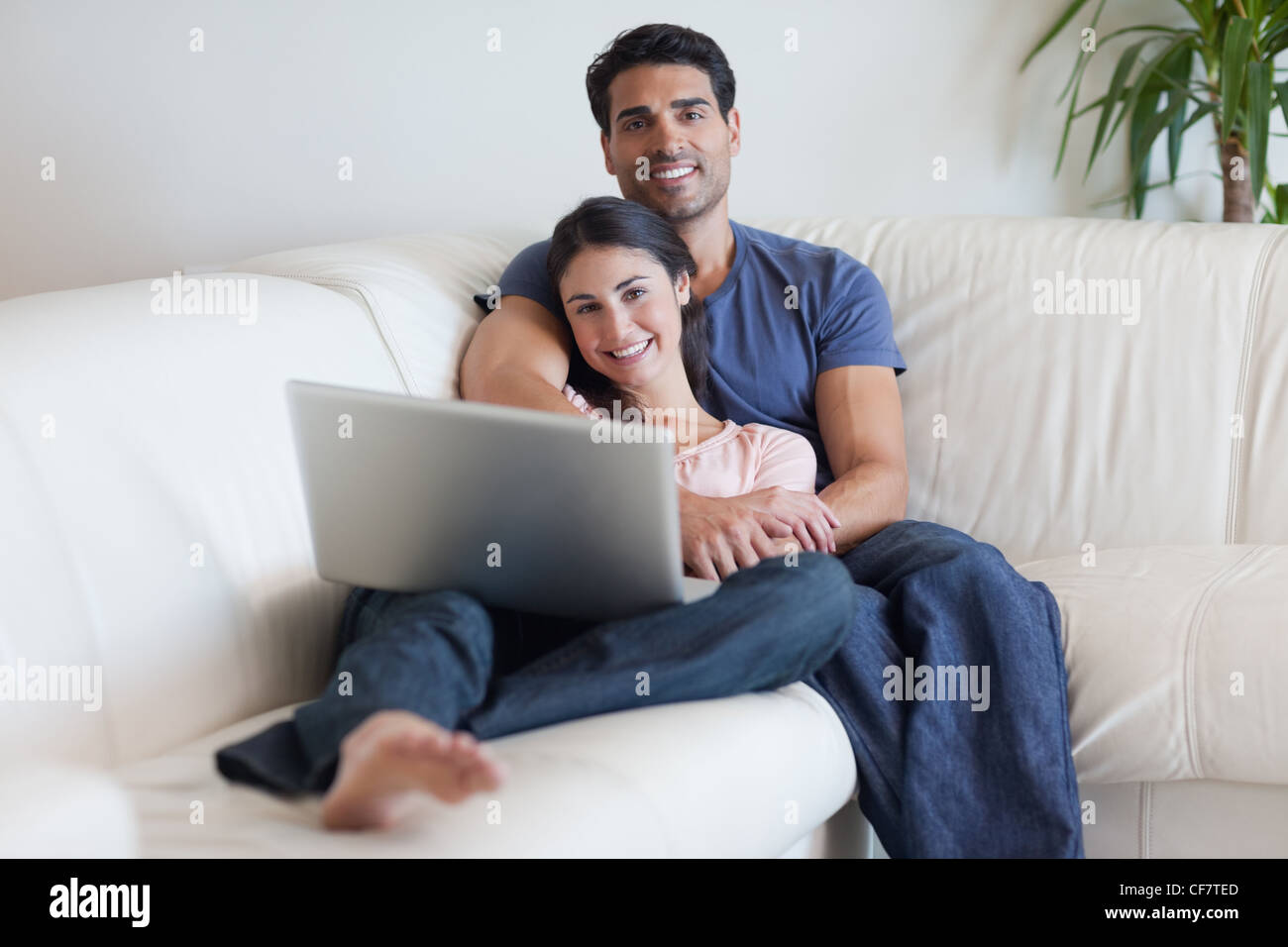 Couple watching a movie with a laptop Stock Photo - Alamy
