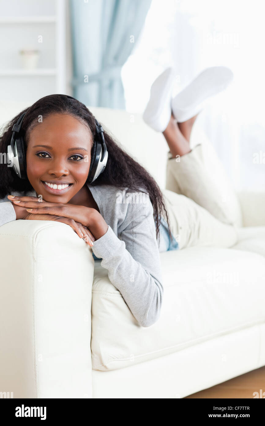 Woman enjoying music on her sofa Stock Photo - Alamy