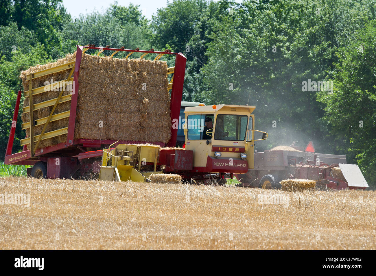 Hay baler operating in field Stock Photo - Alamy