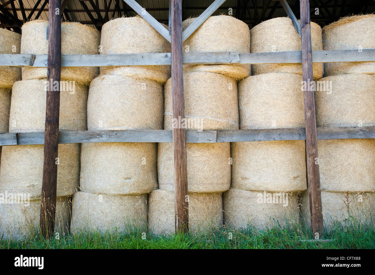 Hay bales stacked in barn Stock Photo - Alamy