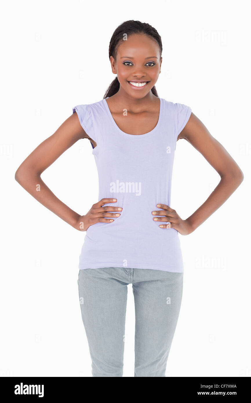 Close up of young woman with arms akimbo on white background Stock ...