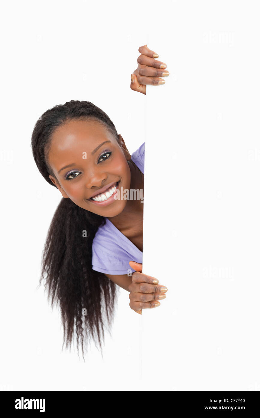 Woman looking around corner hi-res stock photography and images - Alamy