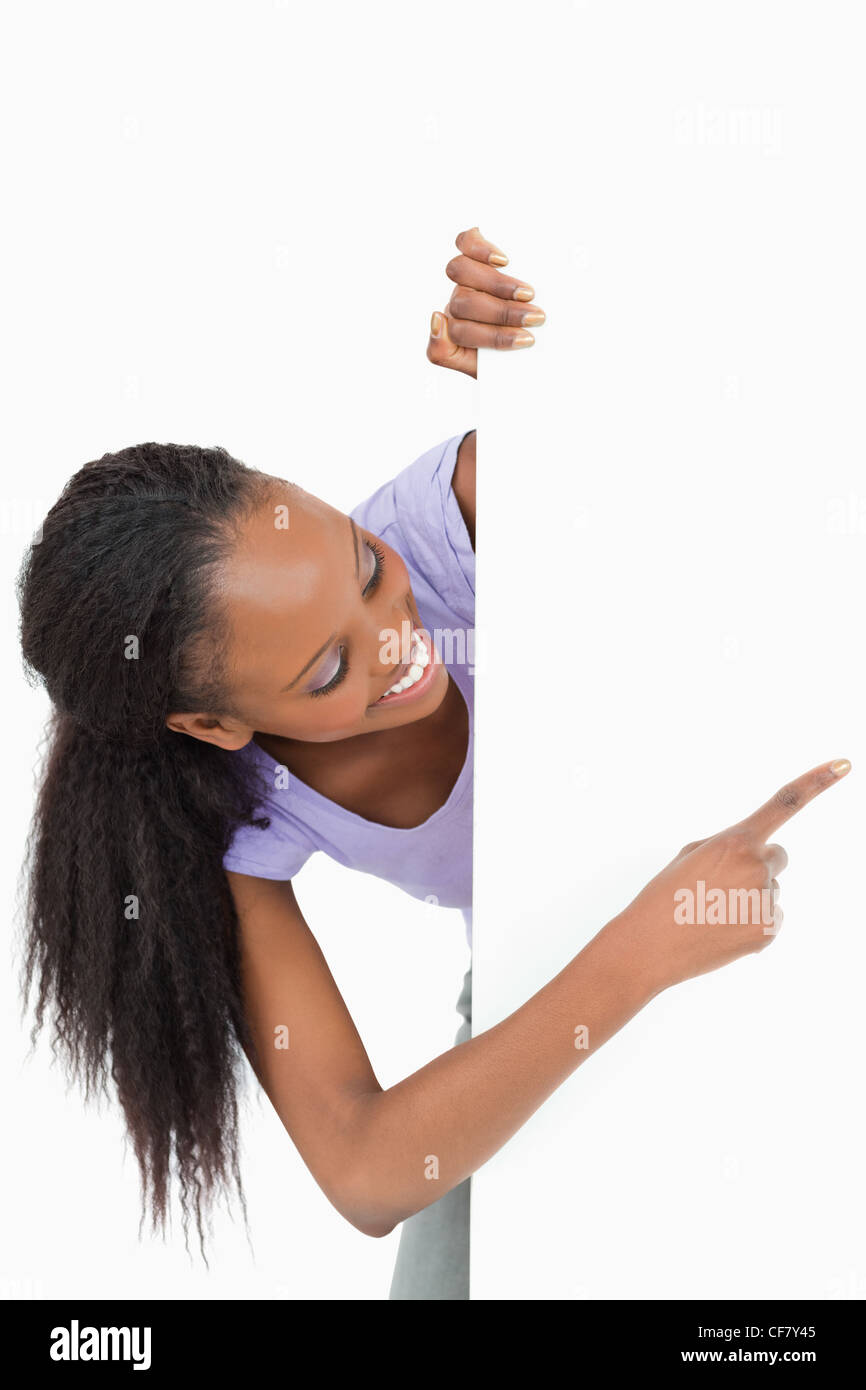 Woman looking around corner hi-res stock photography and images - Alamy