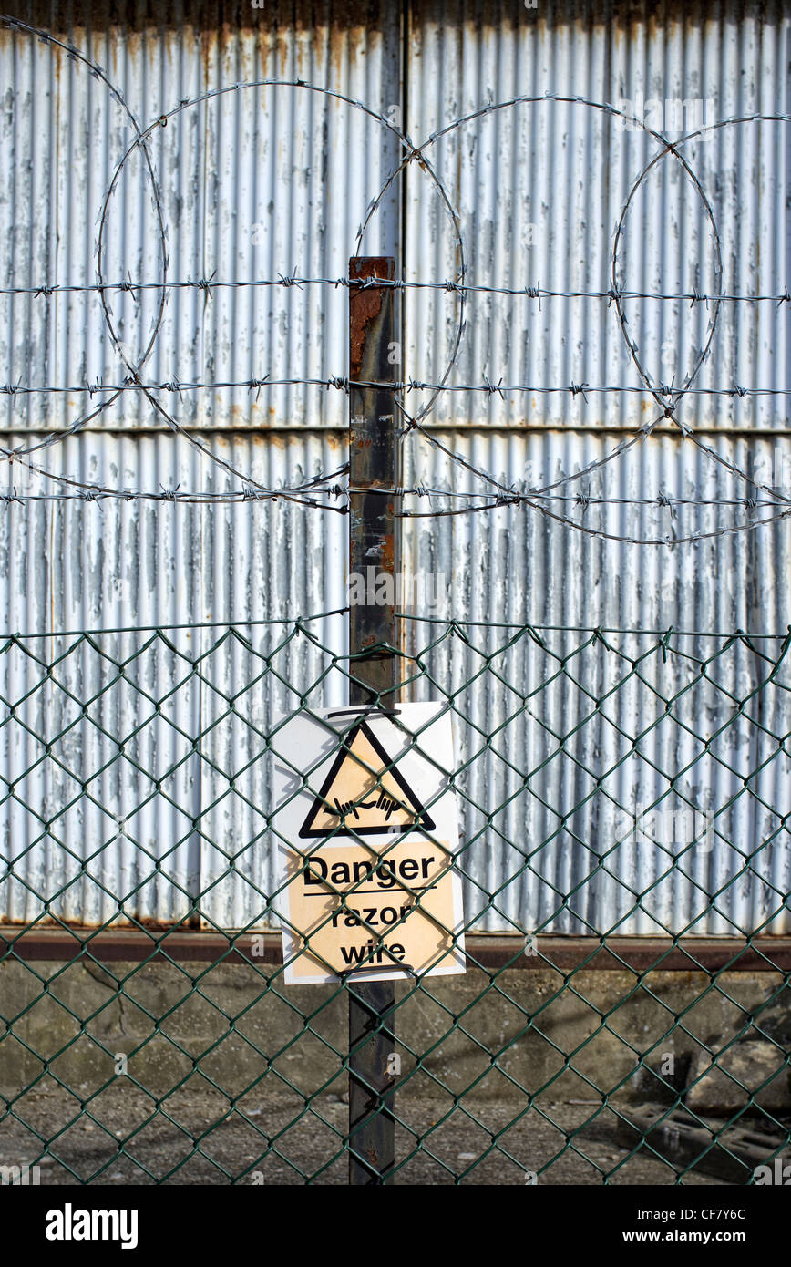 Danger razor wire sign Stock Photo - Alamy