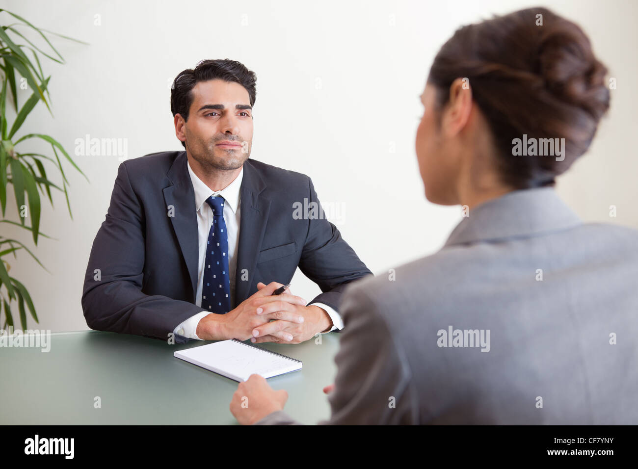 Handsome manager interviewing a female applicant Stock Photo - Alamy