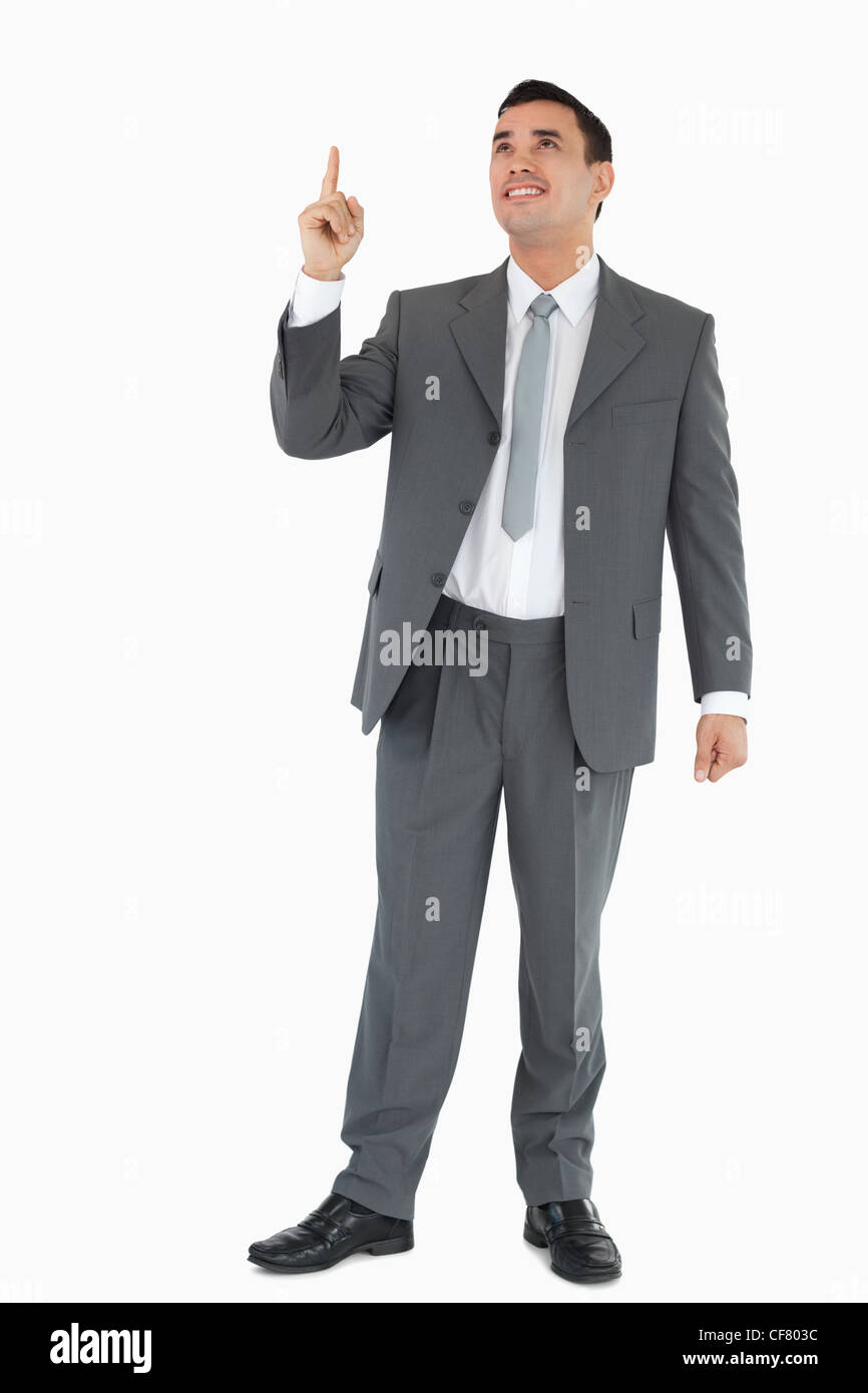 Businessman pointing and looking upwards Stock Photo - Alamy