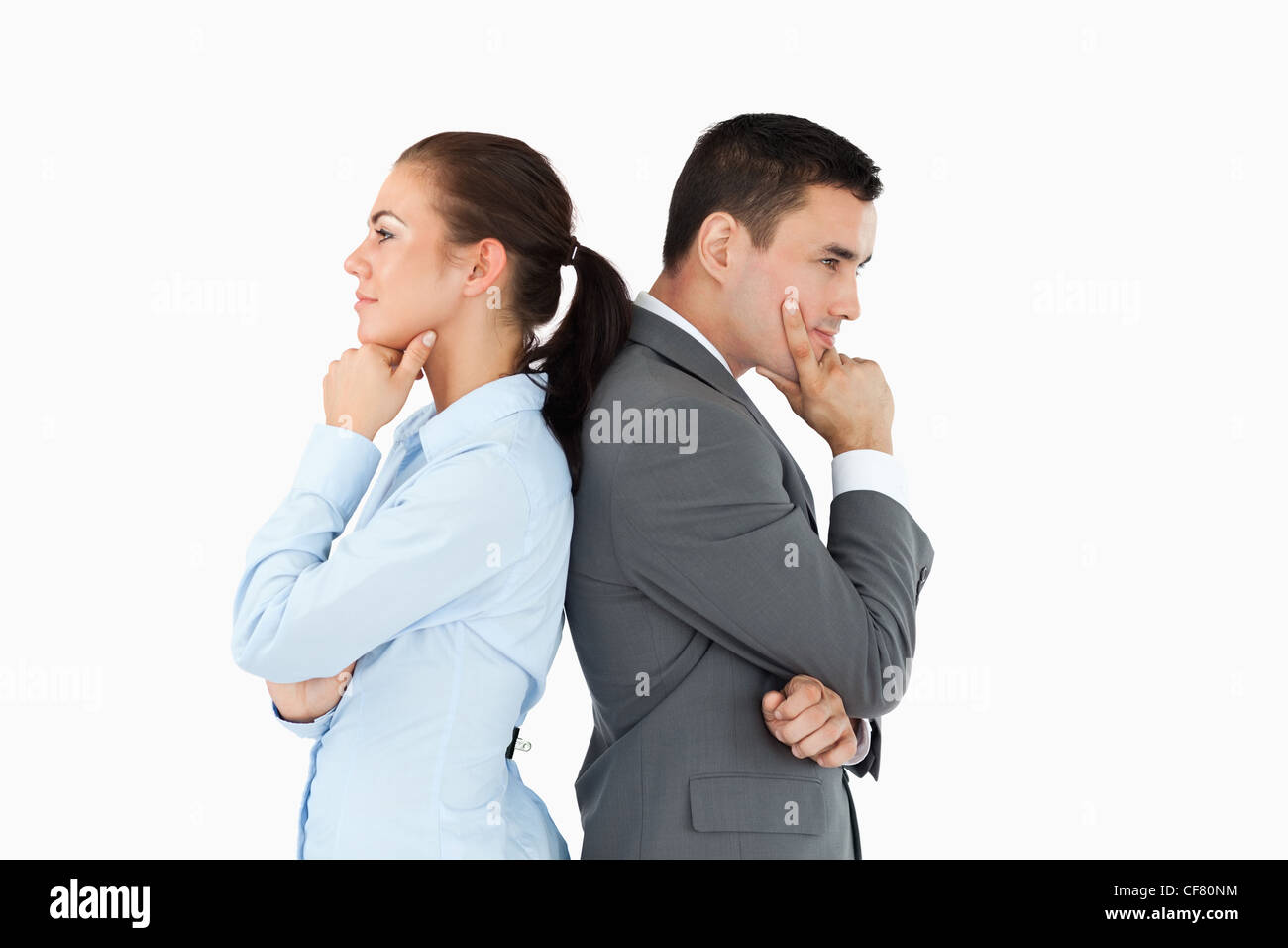 Thinking business partners back-to-back Stock Photo - Alamy