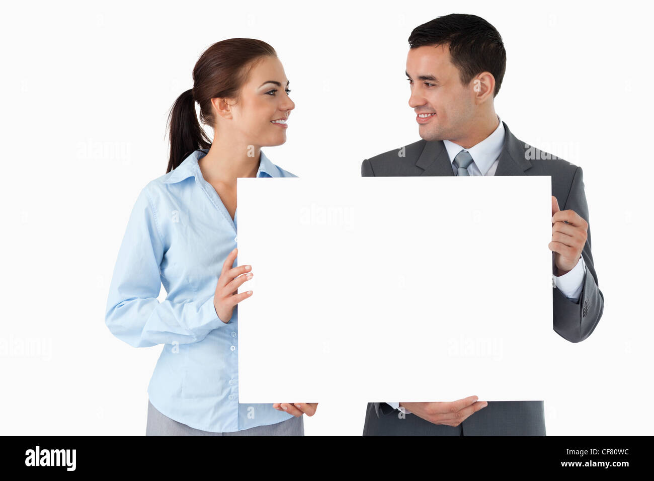 Young business partners presenting sign Stock Photo - Alamy