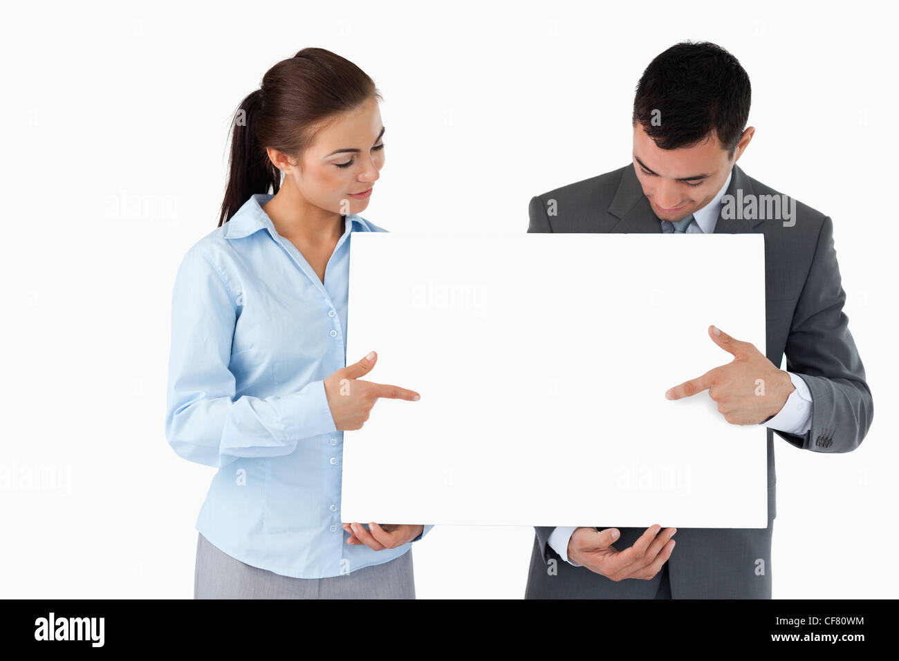 Business partners pointing at sign they are presenting Stock Photo - Alamy