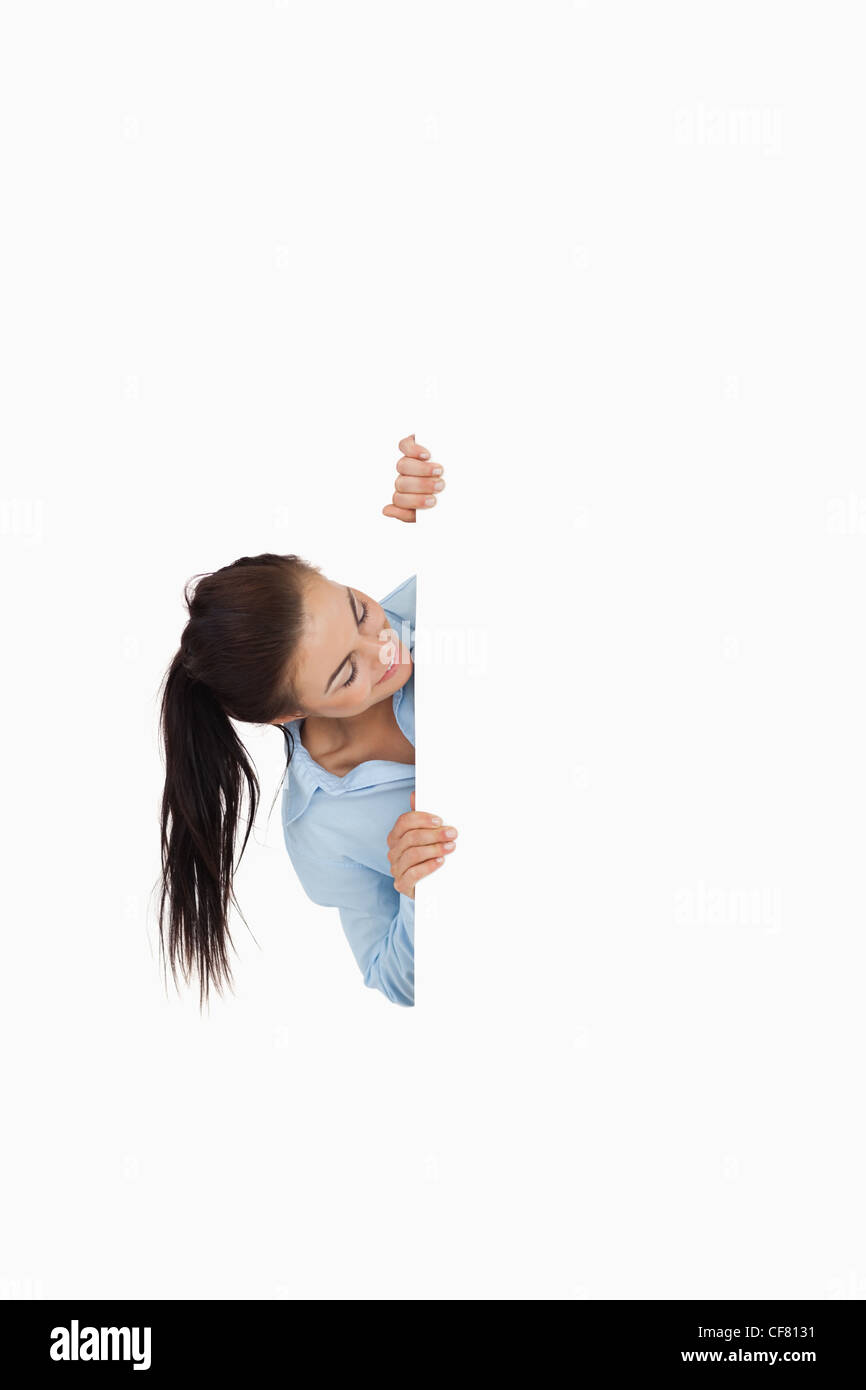 Woman looking around corner behind hi-res stock photography and images ...