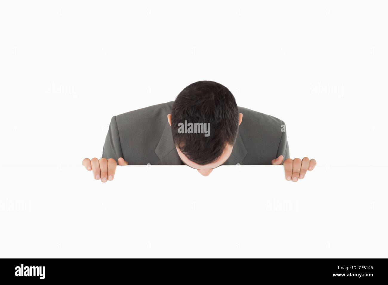 Businessman looking down on sign Stock Photo - Alamy
