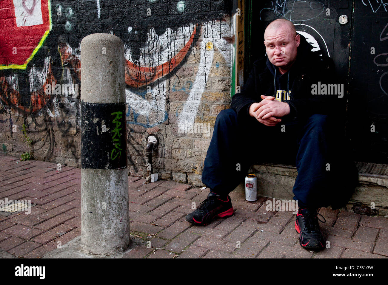Homeless man John sitting in Spitalfields London. Drinking a can of ...